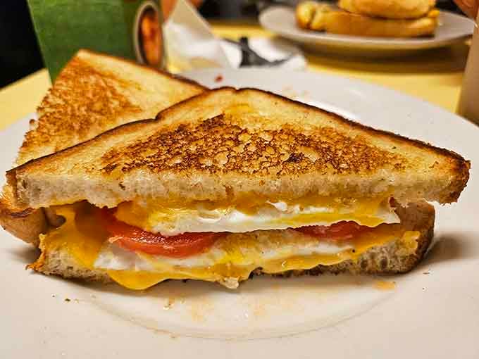 A breakfast sandwich stacked with eggs, cheese, and bacon that makes you question why anyone complicates breakfast.