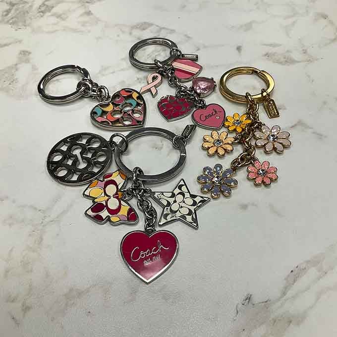 Jingling proof that good things come in small packages. These Coach keychains add designer flair to your everyday carry without emptying your wallet.