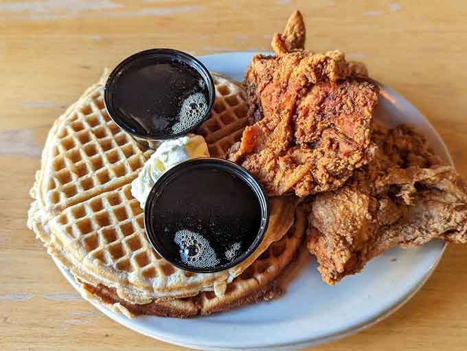 Classic chicken and waffles with syrup ready to bridge that sweet-savory divide like culinary diplomacy at work.