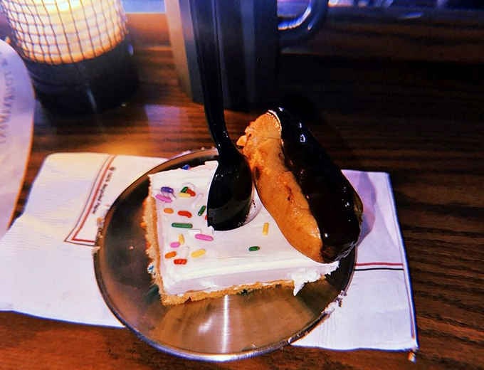 Dessert arrives looking like it survived a chocolate avalanche, sprinkles included for maximum festive chaos.