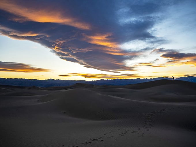 Sunset paints the dunes in fiery oranges and purples, making every photographer's heart skip several grateful beats.