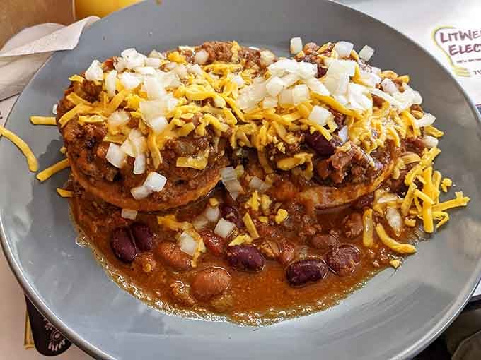 The Mexican Slopper arrives like a delicious geological formation&mdash;layers of chili, cheese, and biscuits creating a topography of flavor.