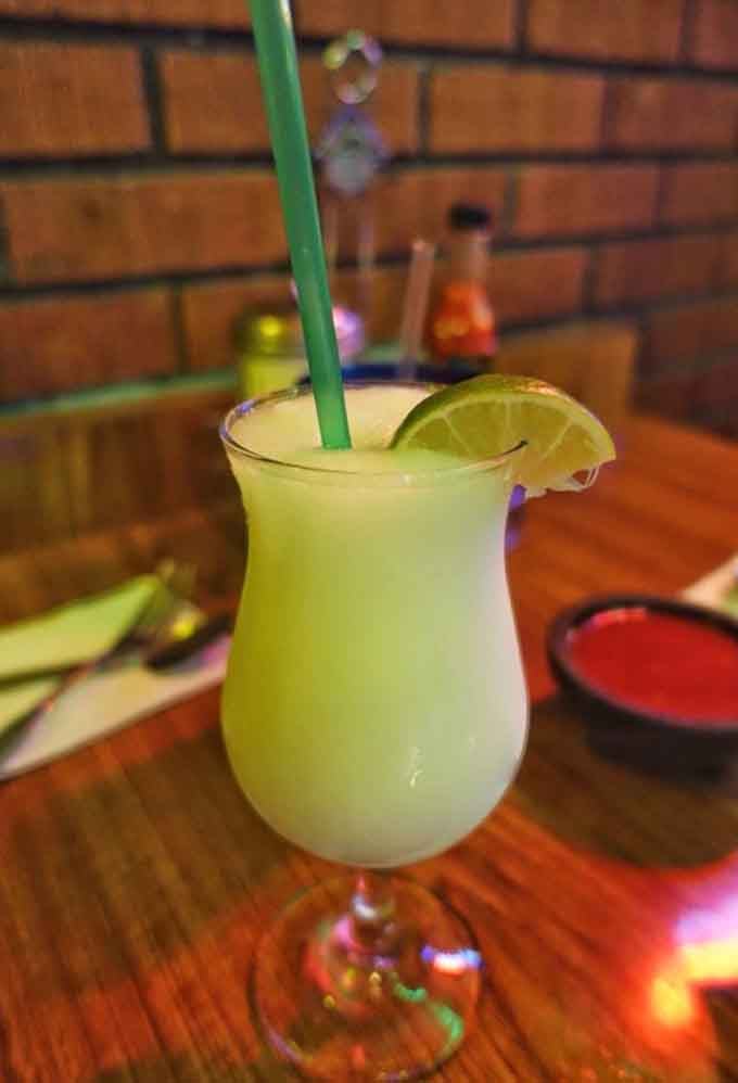 A piña colada margarita that tastes like vacation in a glass, complete with lime and tropical dreams.