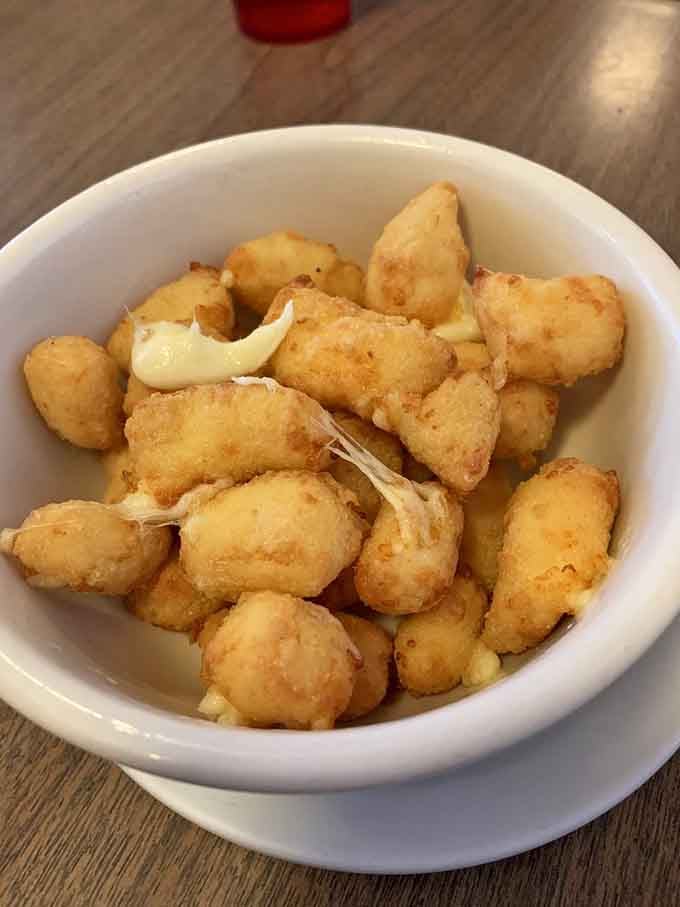 Golden cheese curds that squeak when you bite them, the Wisconsin handshake in fried form.
