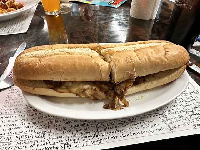 This steak sandwich stretches across the plate like it's trying to escape, but you'll catch it soon enough.