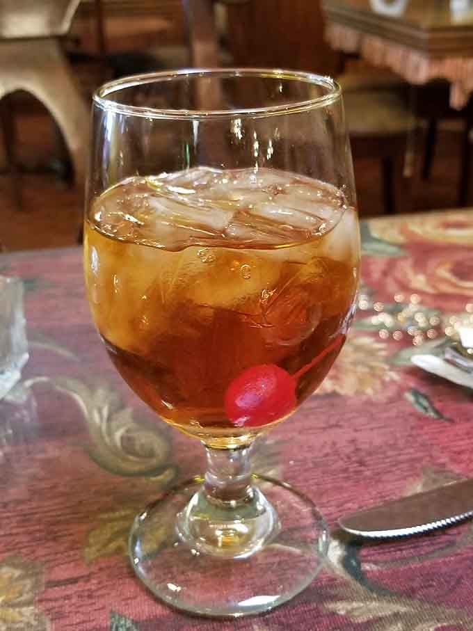 That cherry iced tea catches the light like liquid ruby, sweet enough to make you forget you're technically an adult.