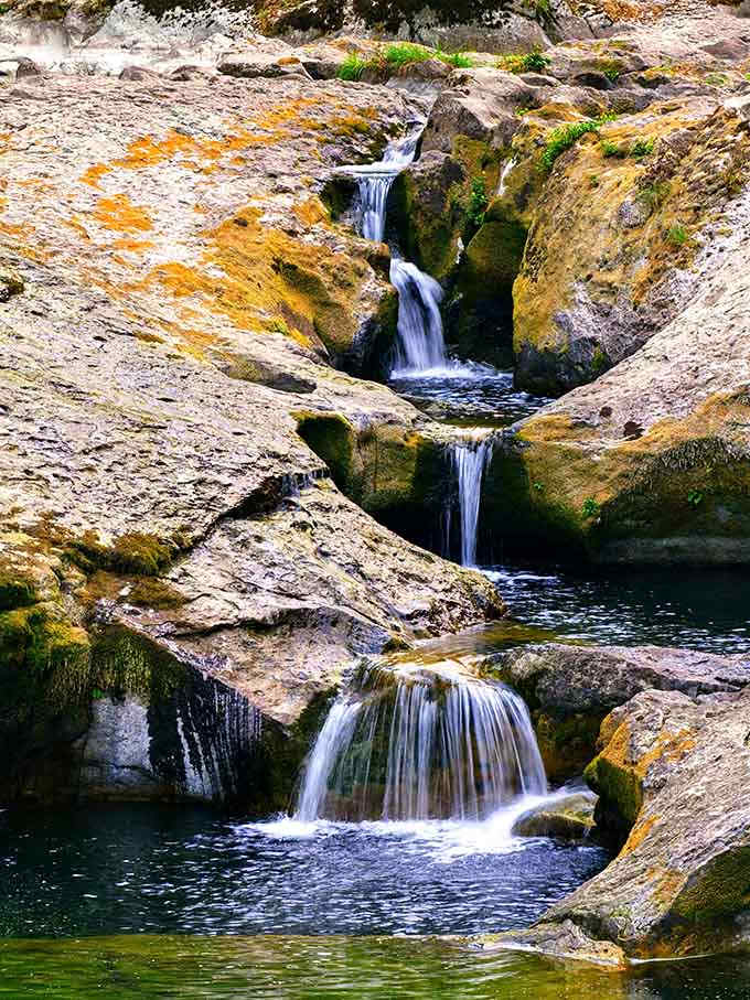 These tiered cascades create their own miniature water park, proving nature invented the lazy river concept long before theme parks.