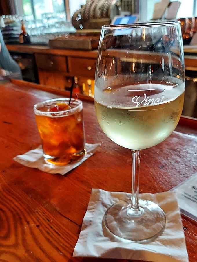 A glass of wine and a classic cocktail waiting at the bar, ready to start your evening off right.