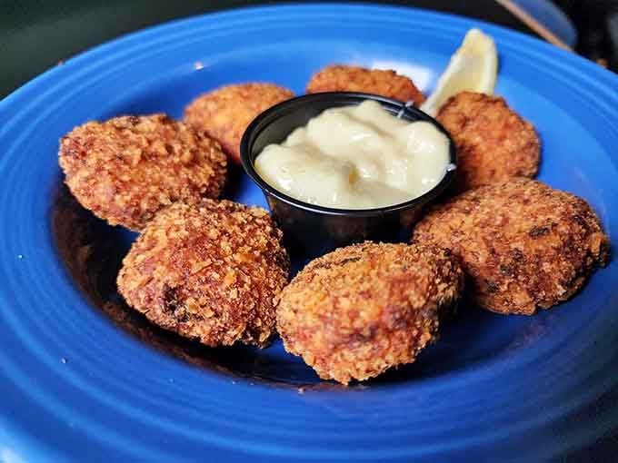 Golden-brown crab nuggets that crunch then yield, revealing sweet meat within. Like little treasure chests of flavor with a dipping sauce moat.
