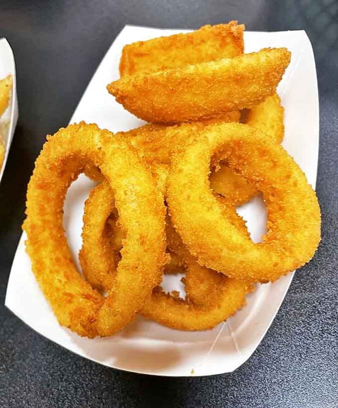 These onion rings aren't just fried &ndash; they're golden halos of crunch that make you wonder why vegetables ever bothered growing any other way.