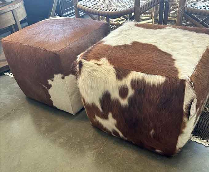 Cowhide ottomans that bring a touch of ranch life indoors, without the inconvenience of actual ranching.