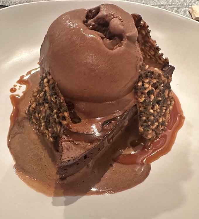 This decadent miso brownie topped with chocolate ice cream delivers the kind of dessert that makes you reconsider sharing.