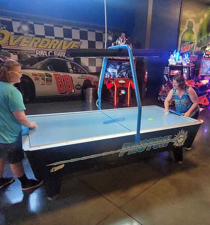 Air hockey provides the perfect cool-down activity after racing, though competitive spirits rarely take actual breaks here.