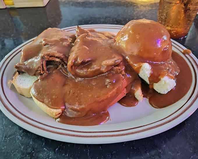 Hot roast beef drowning in gravy over white bread: pure Midwestern comfort that warms the soul.
