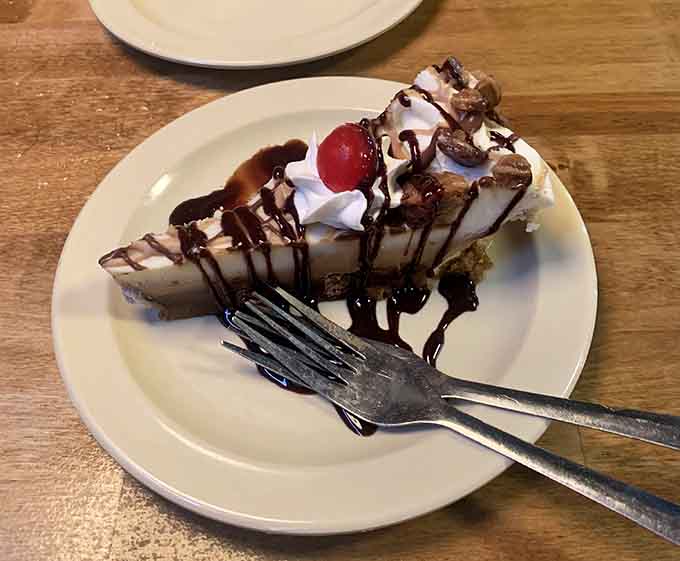 Peanut butter pie topped with whipped cream and chocolate drizzle, because sometimes you need dessert after all that seafood.