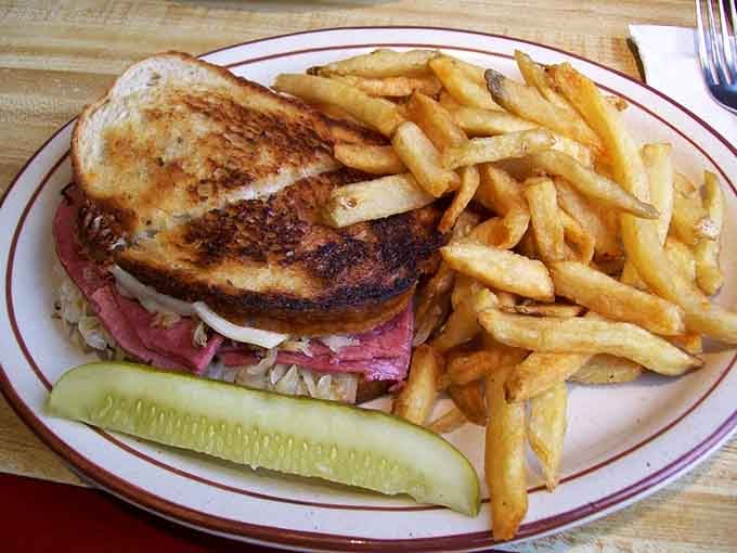 The Reuben arrives stacked tall on rye, corned beef spilling out like it's escaping.