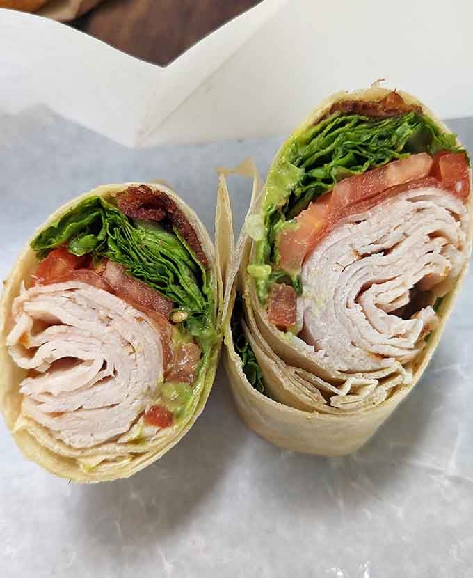 This turkey club wrap is rolled tighter than a yoga instructor and packed with more flavor than seems physically possible.