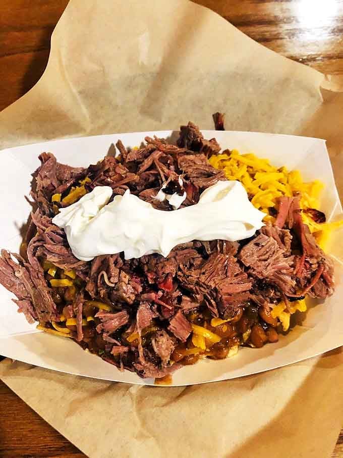 Tender brisket piled high on cheese-laden chips with a dollop of cool sour cream&mdash;a beautiful mess worth every napkin.