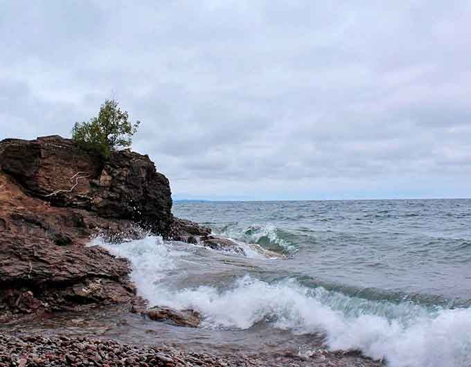 When Lake Superior gets moody, the waves crash against ancient rocks in a dramatic performance worthy of applause.