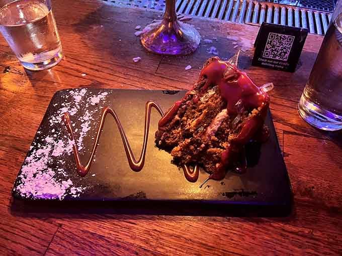 Chocolate cake so rich it makes your retirement account jealous, served with appropriate theatrical flair.