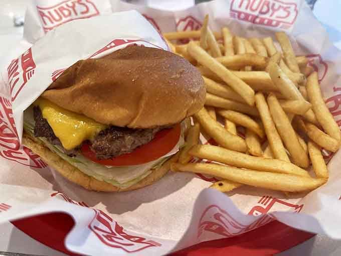 A perfectly assembled cheeseburger with golden fries, the kind of meal that restores your faith in diners.
