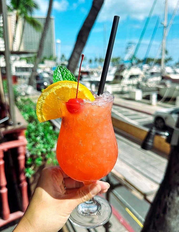 Sunset in a glass: a tropical cocktail with the perfect ratio of rum to fruit juice, garnished with nature's candy.