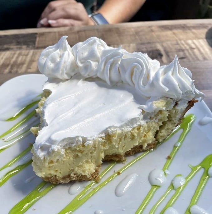 Key lime pie topped with clouds of meringue, the perfect sweet ending to your salty seafood adventure.
