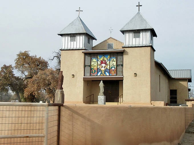 Sangre de Cristo Catholic Church stands as a testament to faith and tradition, its stained glass windows illuminating centuries of New Mexican spirituality.