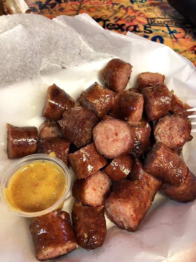 Smoked sausage that snaps with each bite, glistening with flavor. Paired with mustard sauce, it's a reminder that barbecue's supporting cast deserves standing ovations too.