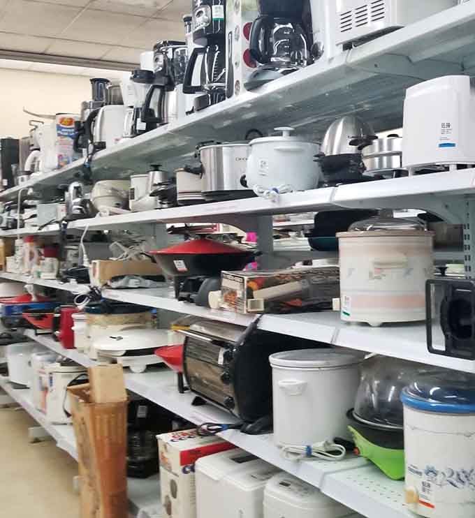 Slow cookers and kitchen appliances stack up like a culinary yard sale from your dreams.