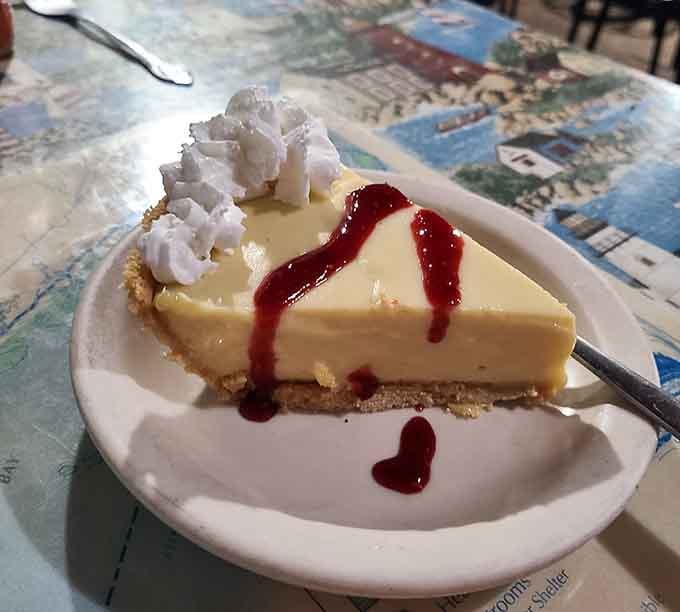 Key lime pie with whipped cream and a drizzle of raspberry sauce&mdash;because sometimes dessert needs to be fancy too.