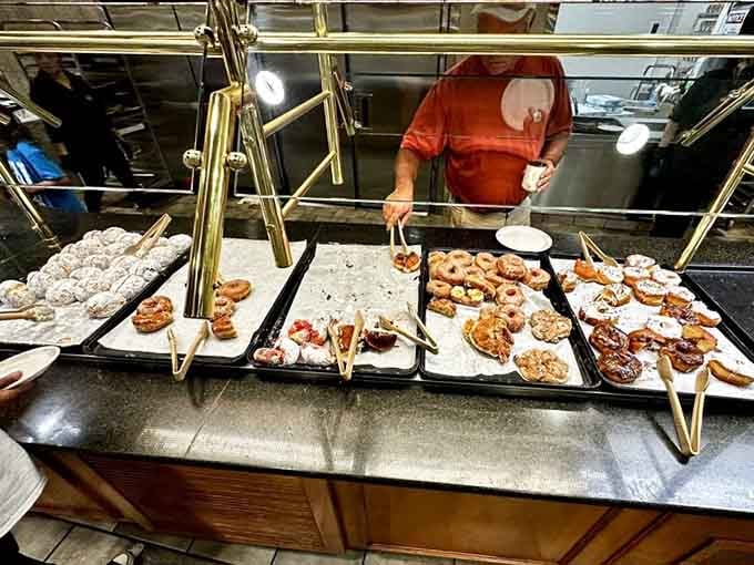 Fresh donuts lined up like sweet soldiers ready for duty, each one a sugary masterpiece of fried dough happiness.