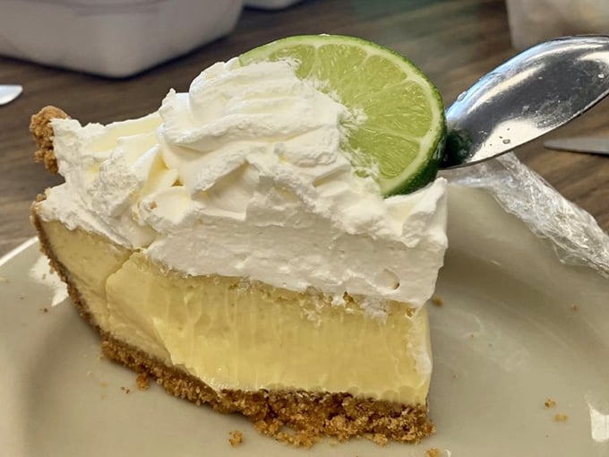 Key lime pie with meringue tall enough to have its own weather system and dreams.