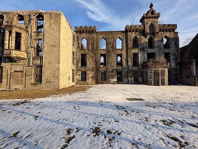 Winter strips away the softness, revealing the skeleton of a building that witnessed unimaginable suffering and courage.