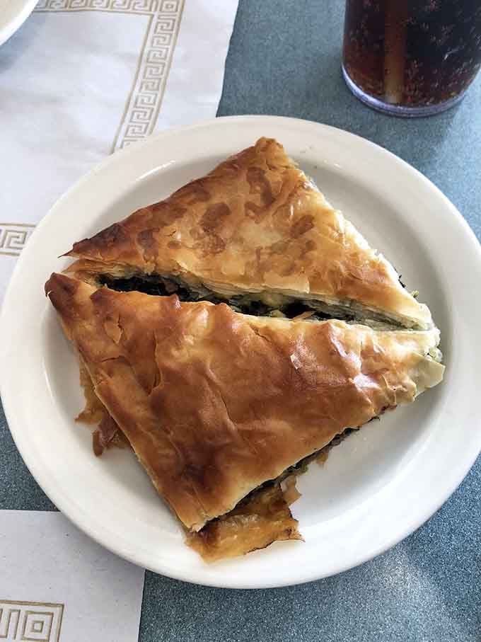 Spanakopita that flakes at first touch, revealing a spinach and feta interior that would make any Greek grandmother nod in approval.