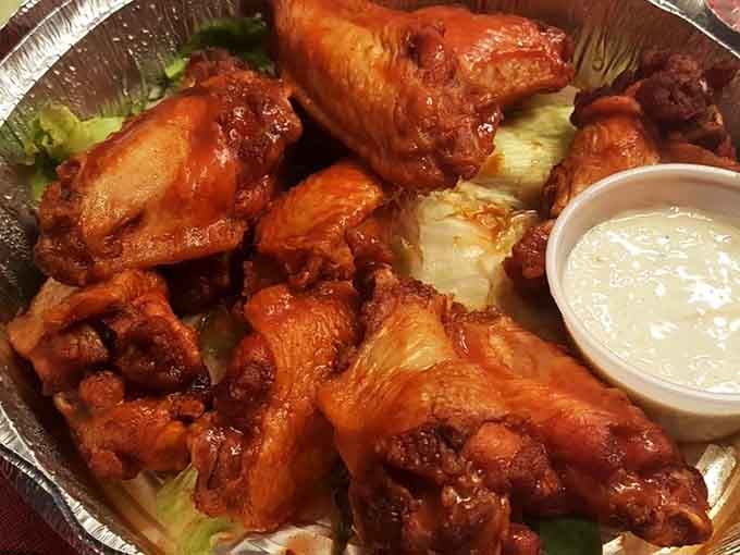 Buffalo wings glistening with sauce and served with cooling blue cheese, because sometimes you need a spicy warm-up act before the beef.
