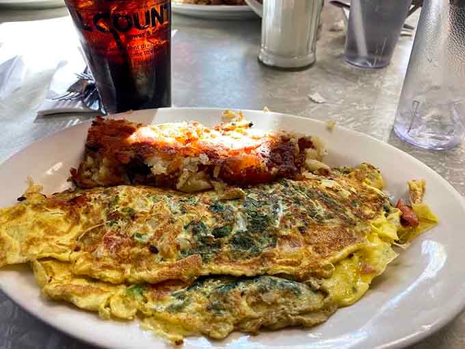 That omelet looks like it's been to culinary finishing school, stuffed with fresh ingredients and folded with precision.
