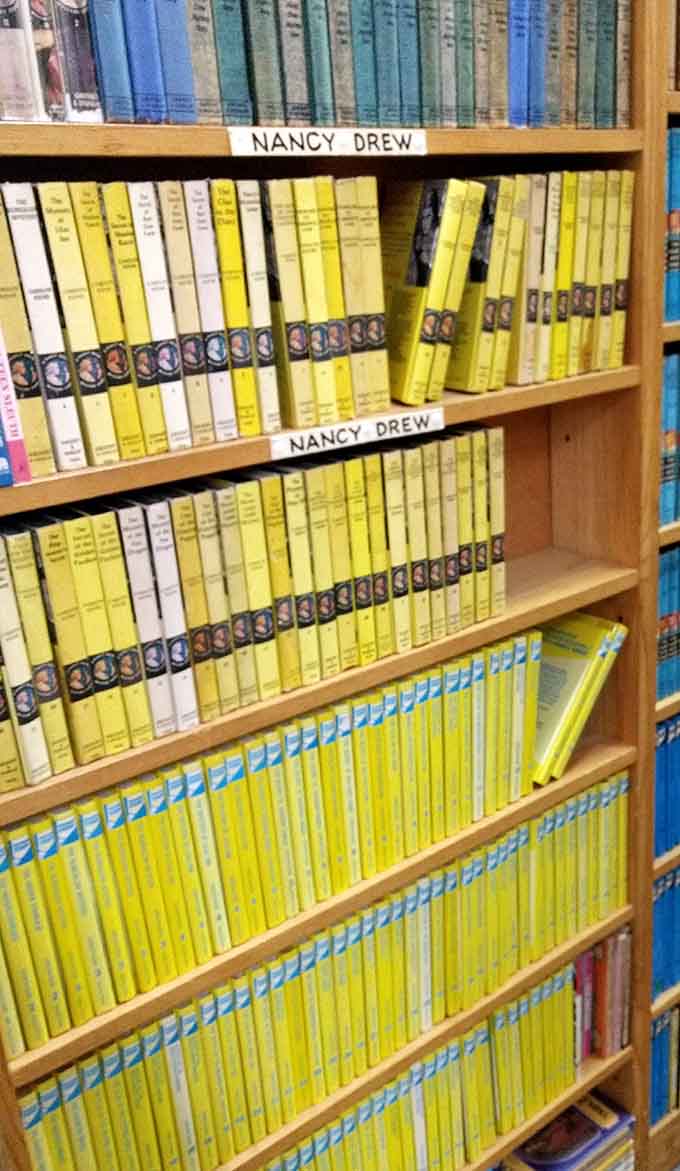 Yellow Nancy Drew volumes stacked like golden bars in a vault for young detective enthusiasts everywhere.