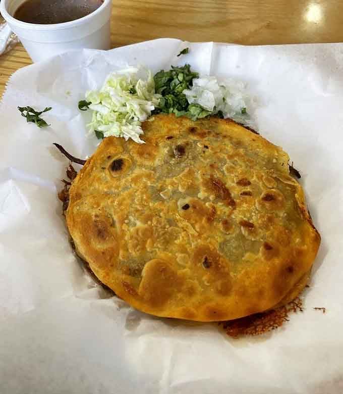 Quesabirria with melted cheese and consomm&eacute; for dipping. This is the comfort food your soul has been craving.