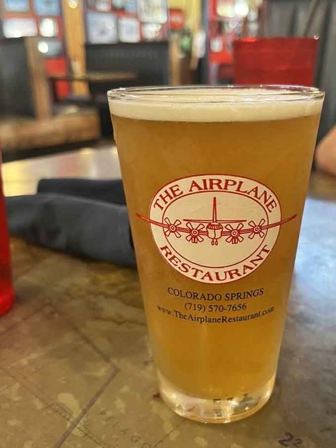Cold beer in a branded glass, because drinking at altitude is more fun when you're safely on the ground.