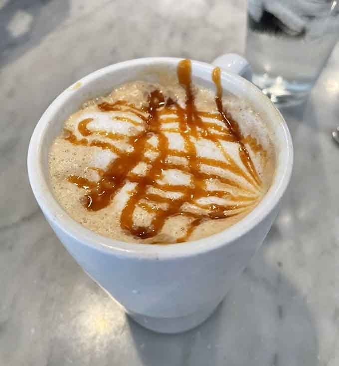 That caramel drizzle pattern suggests someone in the kitchen takes their coffee art very, very seriously indeed.