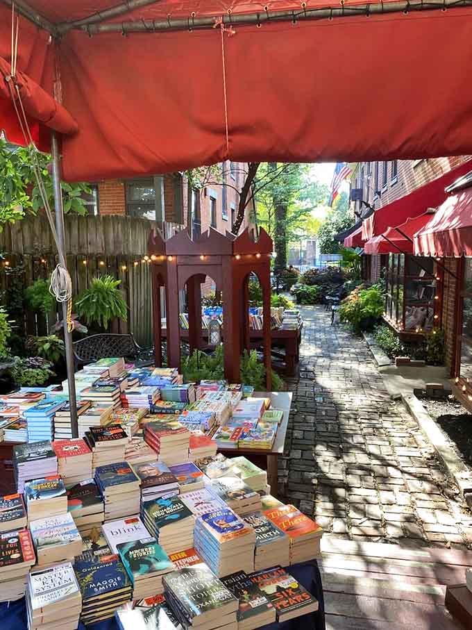 Books basking in the sunshine under red awnings, living their best outdoor literary life in German Village.