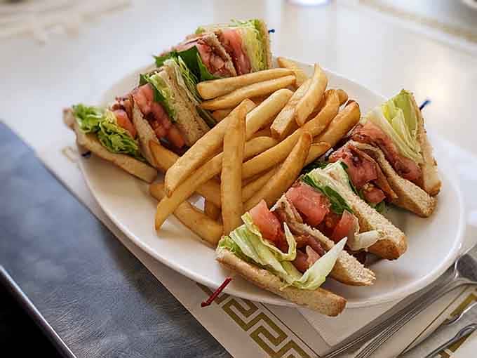 The club sandwich stacked so impressively it requires both hands and possibly a degree in engineering.