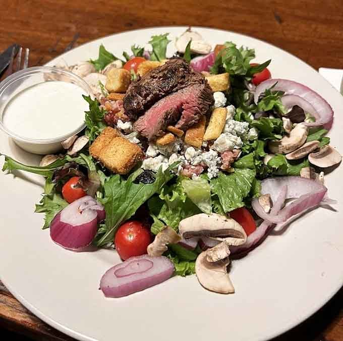 A steak salad so loaded with toppings that calling it a salad feels like a technicality at best.