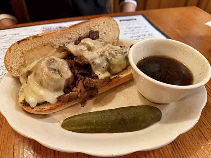 The French dip sandwich arrives with au jus for dunking, turning every bite into a delicious little swimming lesson.