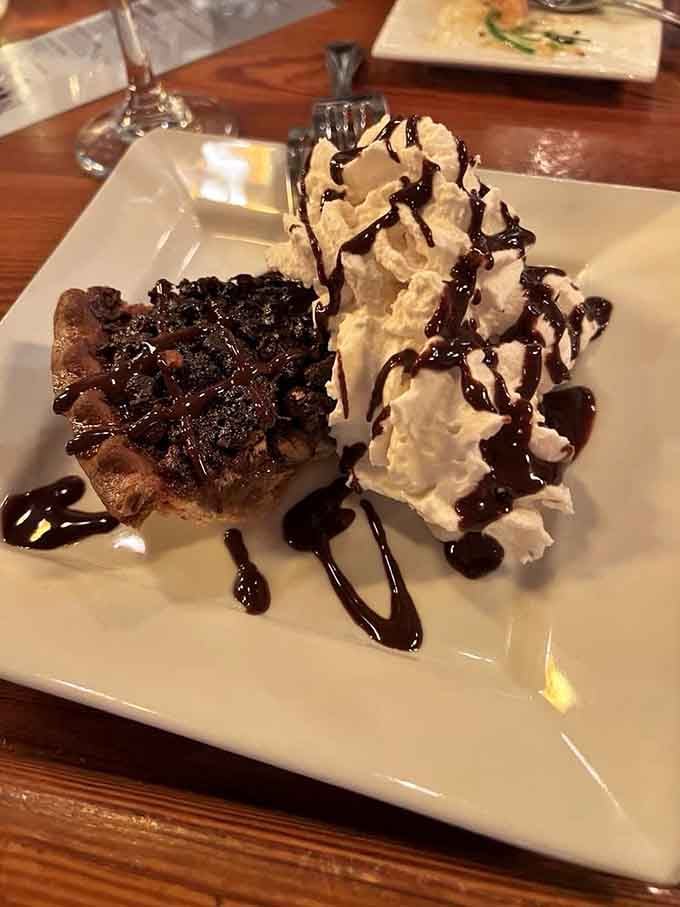 Chocolate pecan pie with whipped cream and that drizzle is the kind of dessert that makes you loosen your belt preemptively.