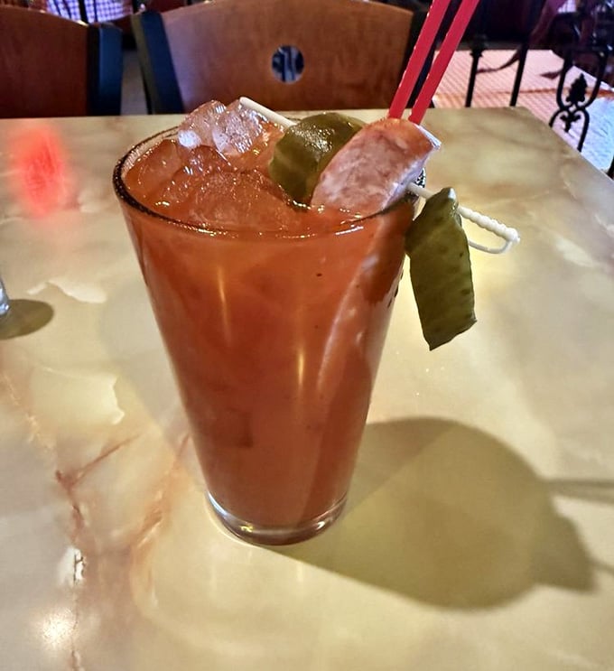 A Bloody Mary garnished with a pickle spear because apparently vegetables count as breakfast when they're pickled.