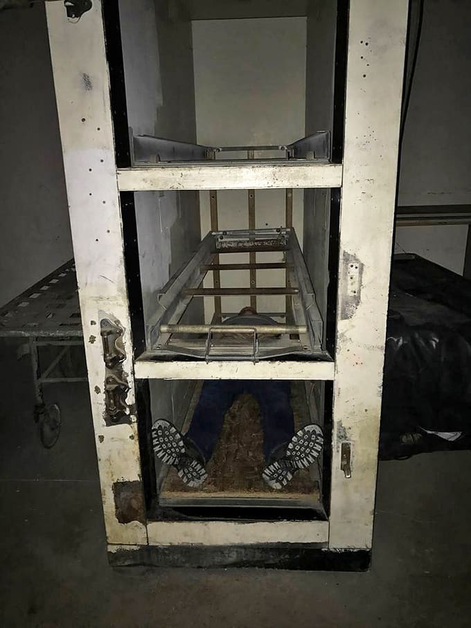 The mortuary equipment remains as a stark reminder of the building's grim purpose during the tuberculosis epidemic years.