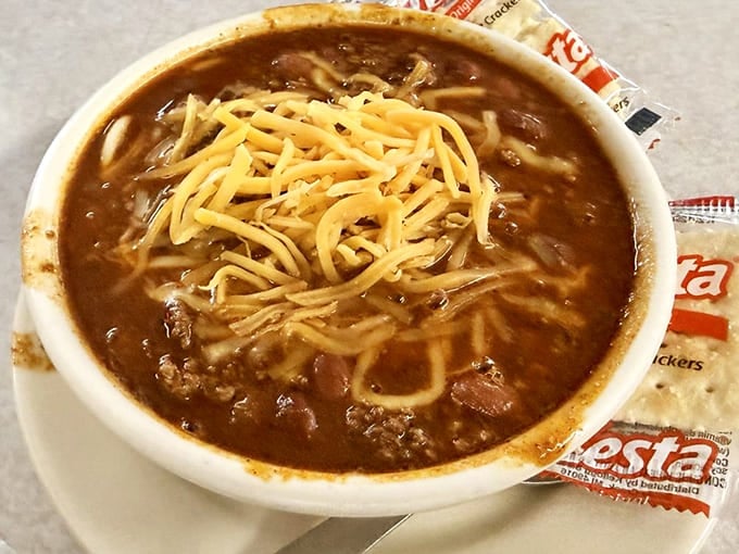 A bowl of chili topped with cheese and onions—comfort food that doesn't need a fancy backstory.