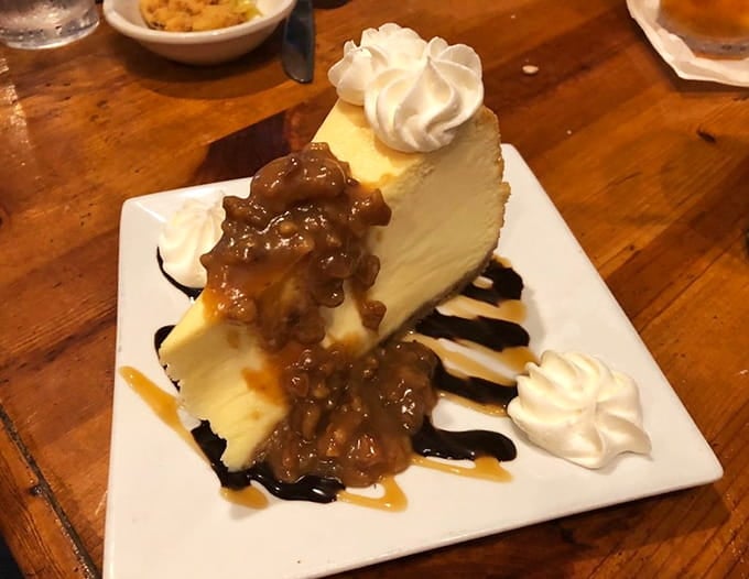 Turtle cheesecake drizzled with caramel and chocolate transforms dessert into a religious experience worth confessing about.